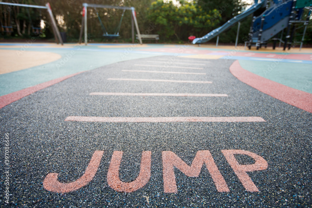 "Jump" written into rubber floor of playground Stock Photo | Adobe Stock
