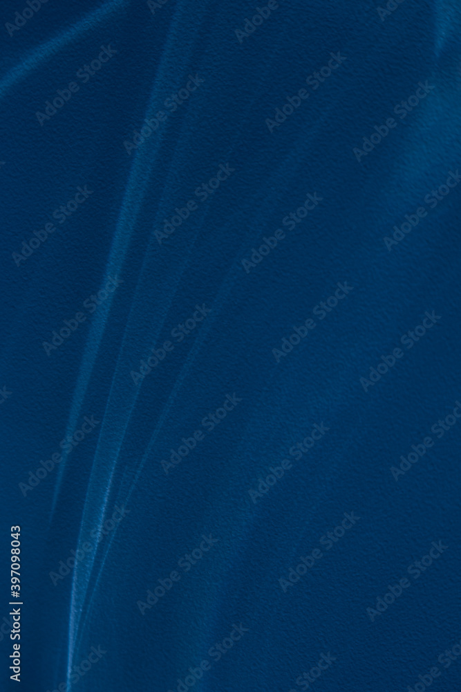 Dark blue background with shadows and shining lines on the textured ...