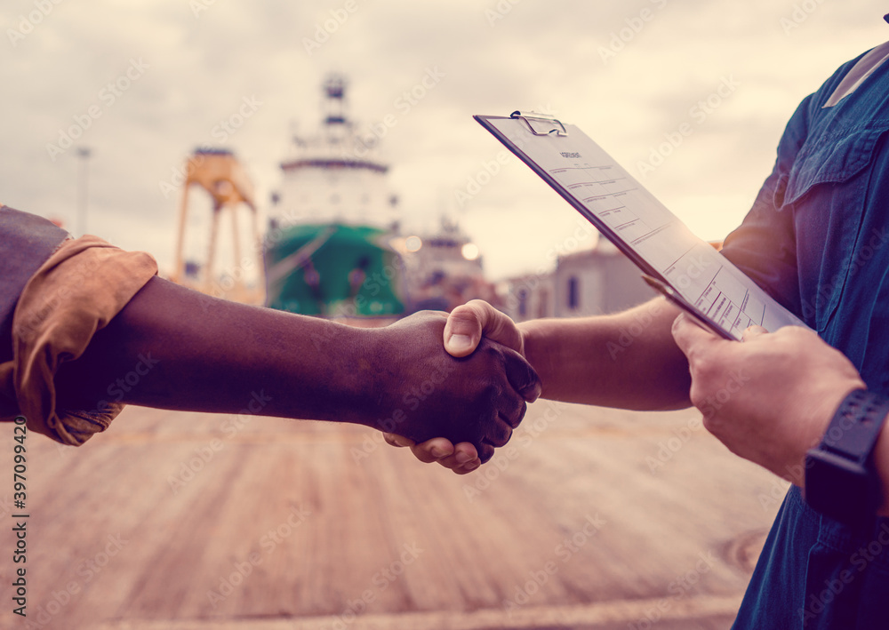 marine contractor businessman handshaking with worker on the ship with ...