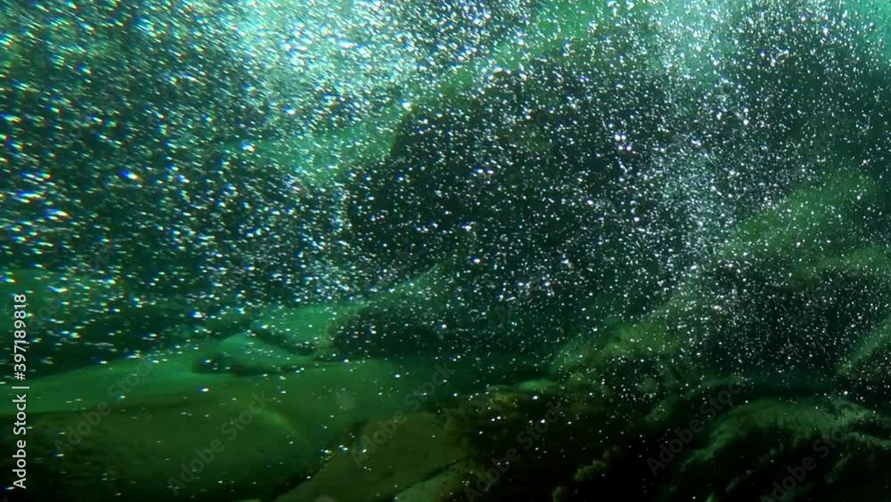 Underwater view of fast flowing waters of mountain pure river and ...