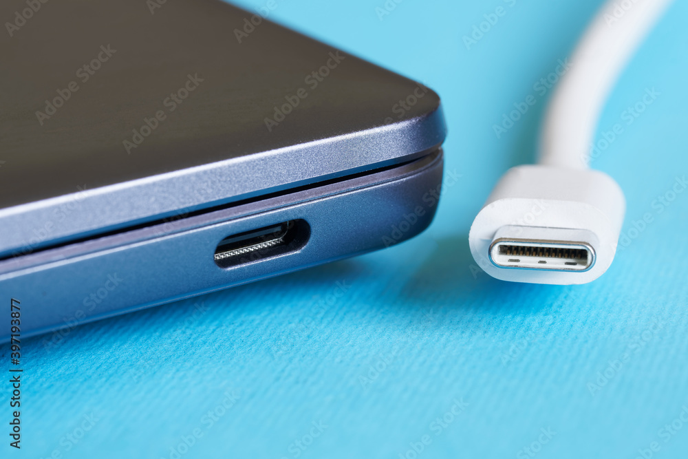 White USB type-c plug and its corresponding port on a modern laptop ...