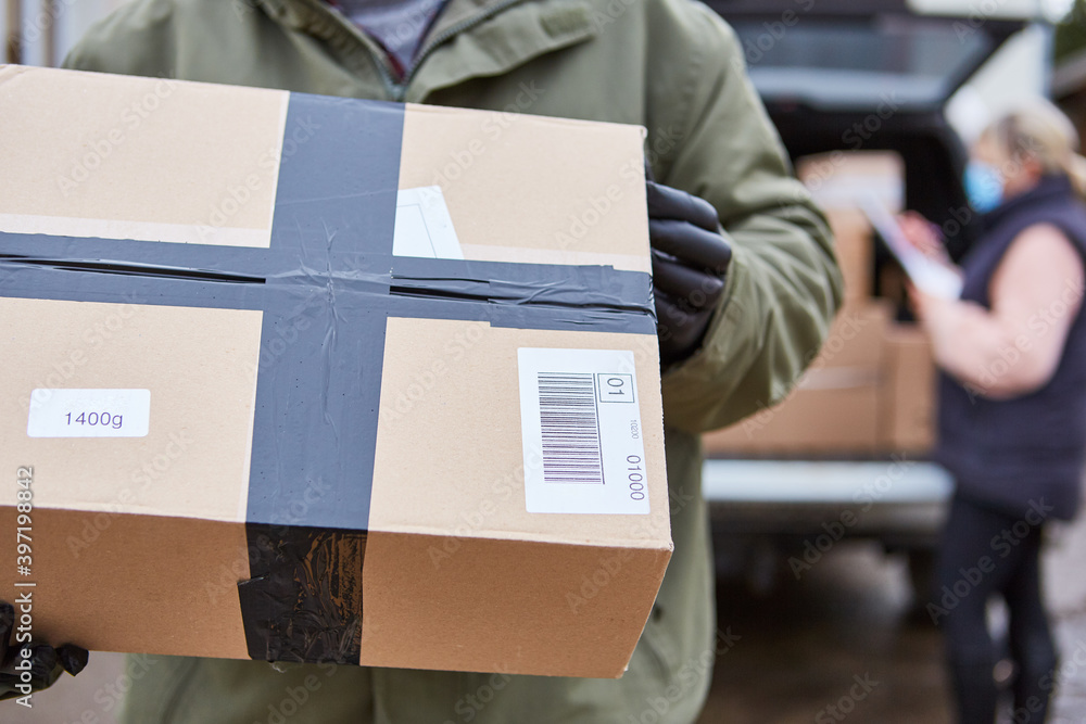 Paket Lieferung wird von Paketboten gehalten Stock Photo | Adobe Stock