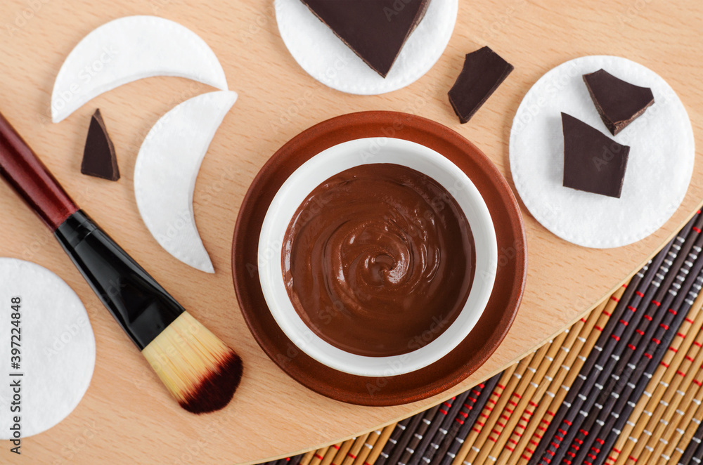 Cocoa (dark chocolate) face and body mask in a bowl. Homemade beauty ...