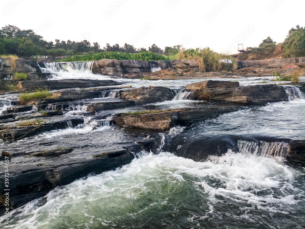 View of a magnificent ‘Bhatinda’ waterfall in the middle of the green ...