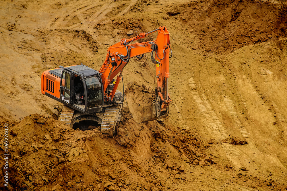excavator moving earth and unloading into a dumper truck Stock Photo ...