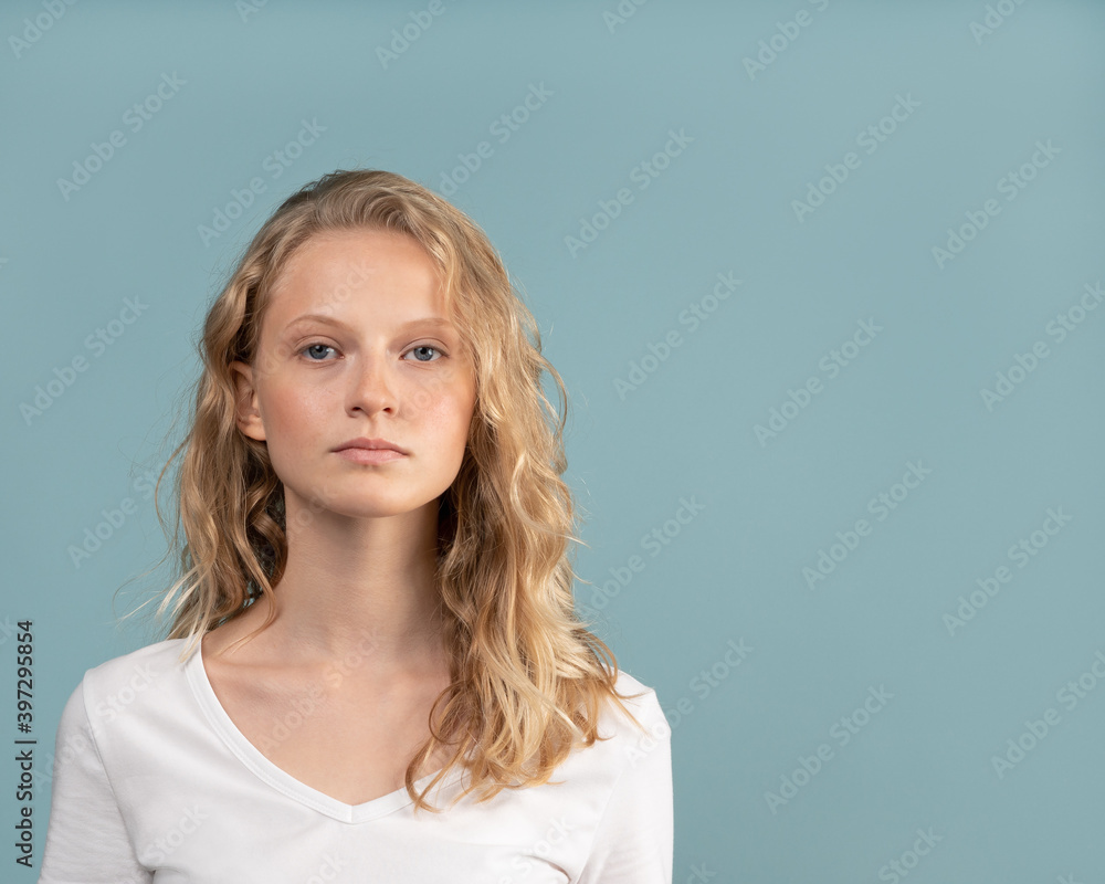Beautiful young serious clever blonde woman without makeup on color ...
