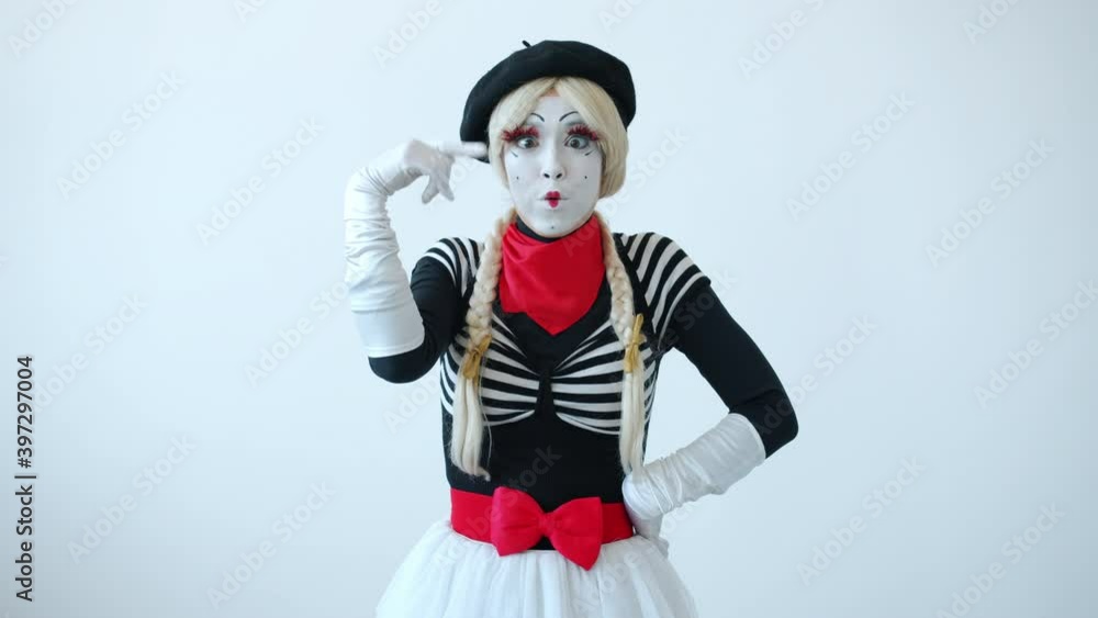 Funny girl pantomimist is making crazy hand gesture shwing cuckoo sign ...