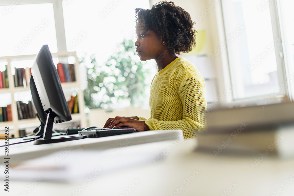 Black student using computer in classroom Stock Photo | Adobe Stock