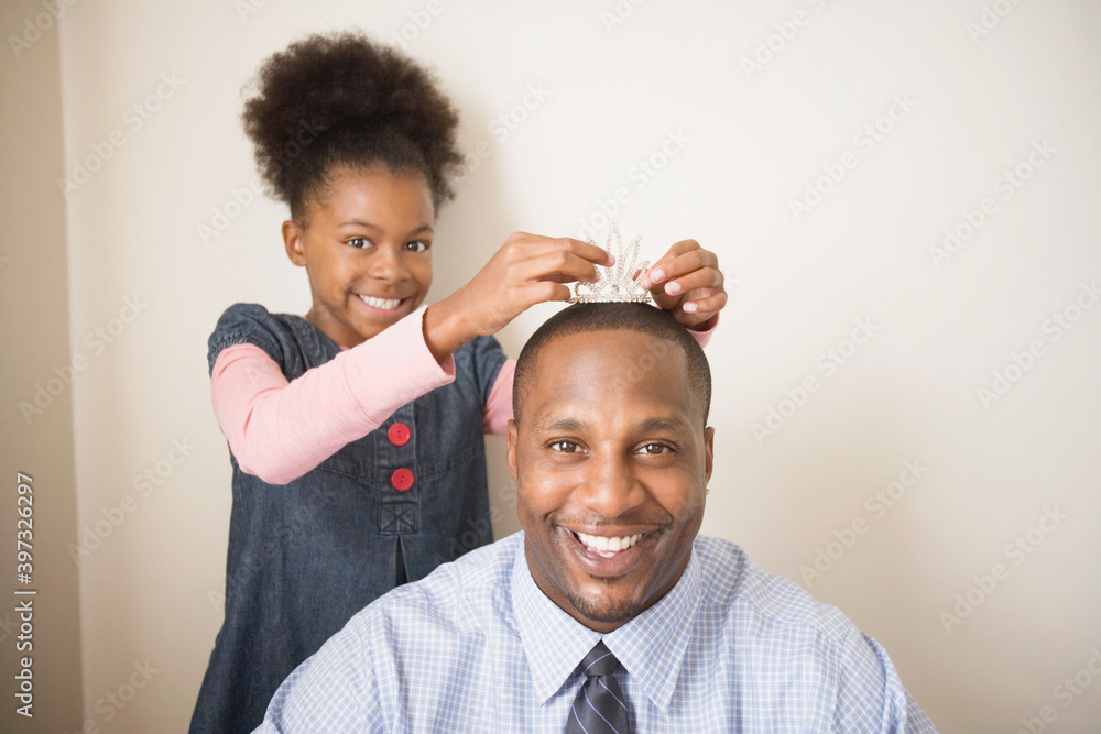 African father wearing daughter's tiara Stock Photo | Adobe Stock