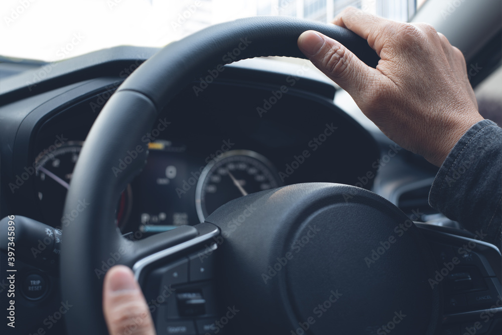 Man turning steering wheel driving a car on the road Stock Photo ...