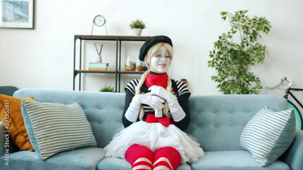 Funny girl mime watching TV changing channels laughing crying feeling ...