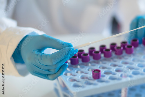 Process of coronavirus testing examination by nurse medic in laboratory ...