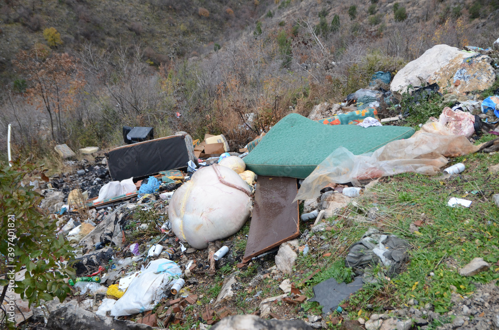 Wild garbage dump in nature. Open landfill site. Pile of garbage ...