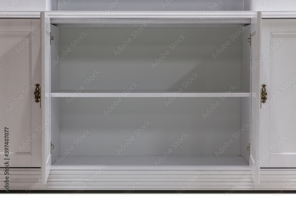 Open doors of a white wooden kitchen cabinet. Close-up of empty kitchen ...