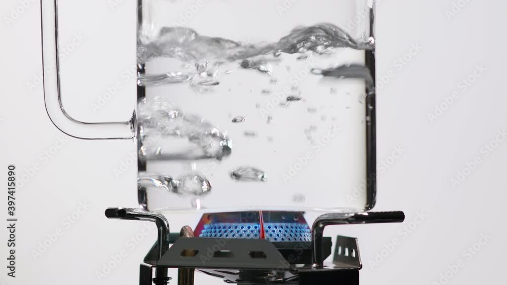 Boiling Water. Liquid Boils in a Transparent container. Water vapor ...
