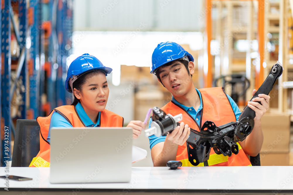 Asian male and female worker in safety vest and helmet working and ...