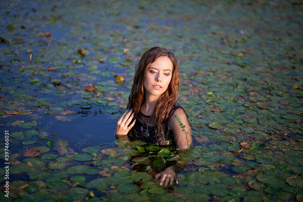 beautiful girl bathes in a swamp, a mermaid in a swamp. Stock Photo ...
