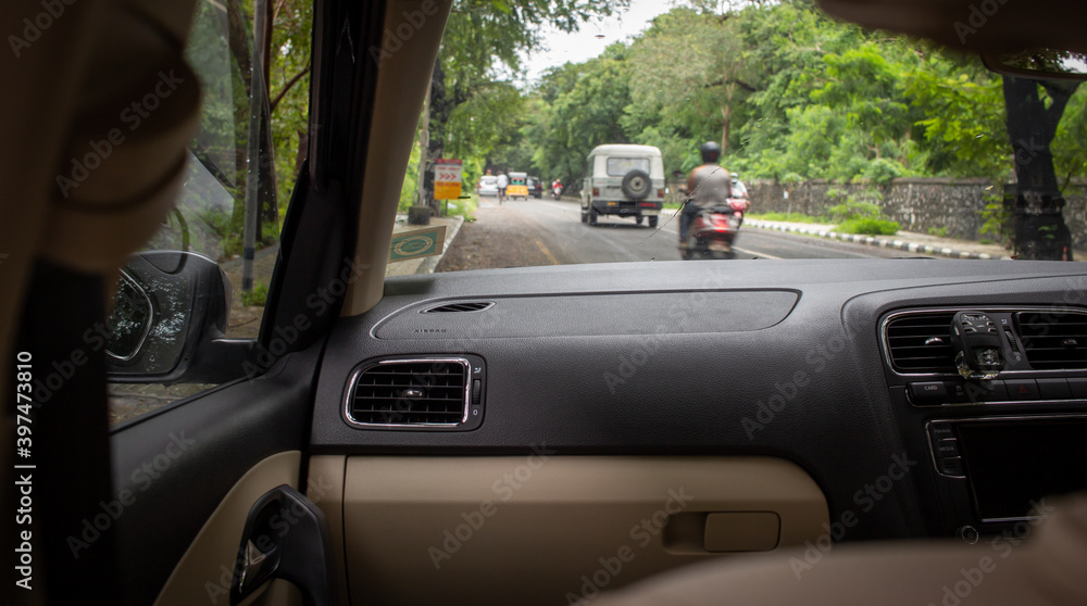 Car interior with view of air conditioner vent, windshield and side ...