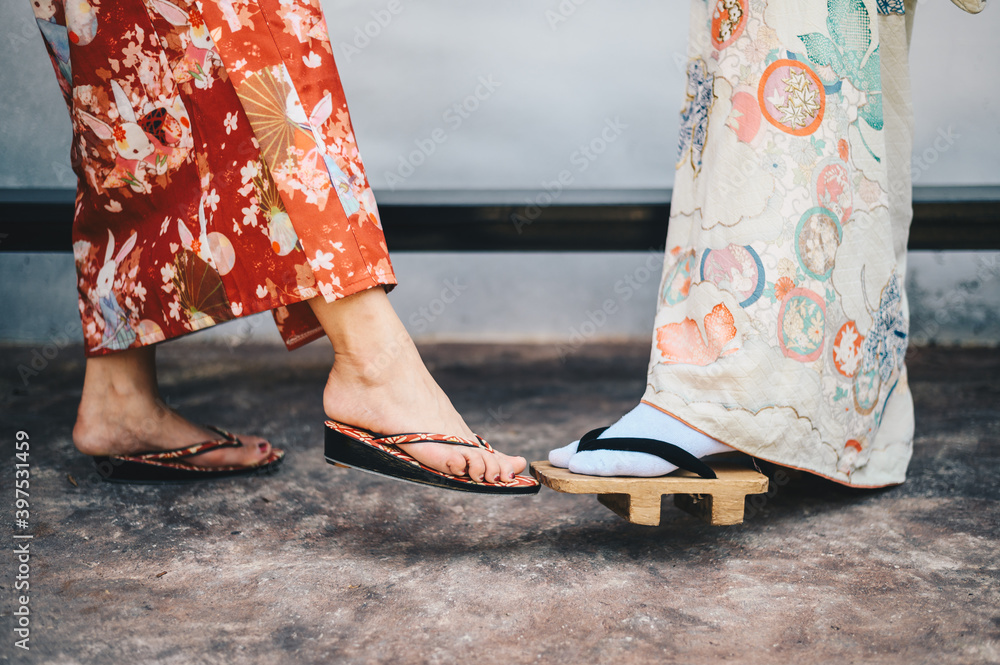 Cropped shot view of Japanese women doing foot tapping for greeting ...