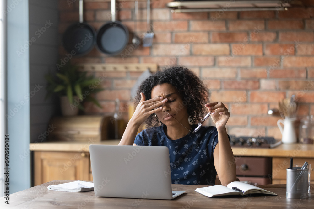 Unhappy young african american woman taking off eyeglasses, feeling ...