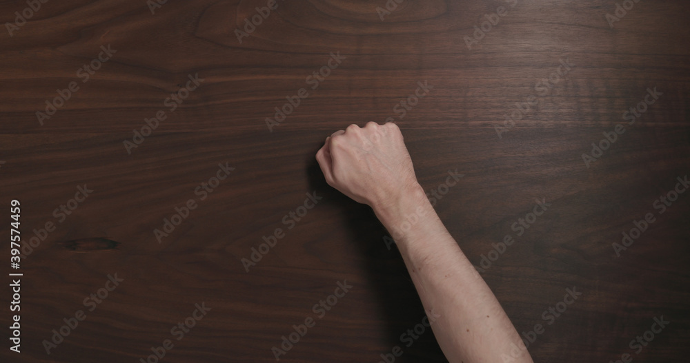 Top view man hand knock on black walnut table with copy space Stock ...