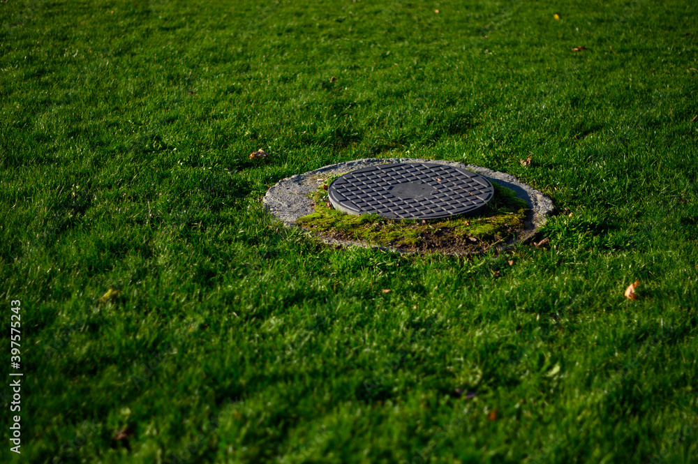 Sewer manholes in the city park, drainage system, reservoirs. Stock ...