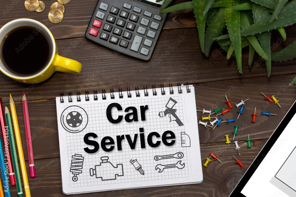 Foto de Notebook with a notes Car Service on the office table with ...