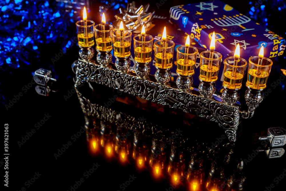 Menorah with oil candles and reflection on surface for Hanukkah jewish ...