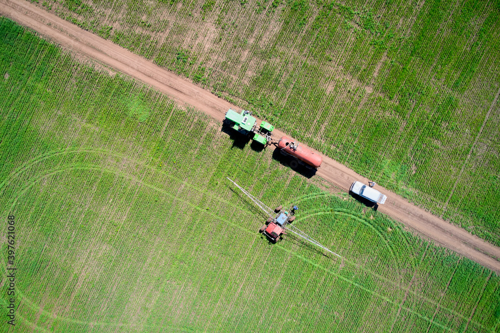 Treatment of the field with herbicides. A tractor with a spray gun ...