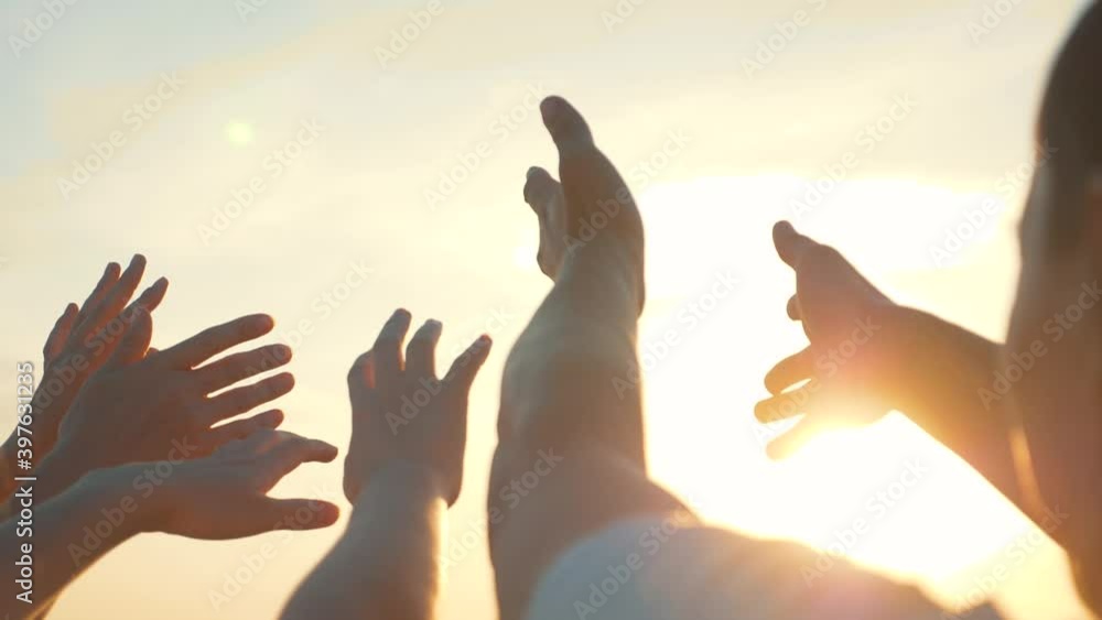 People hands reach out to the sun and god at sunset. Happy family ...