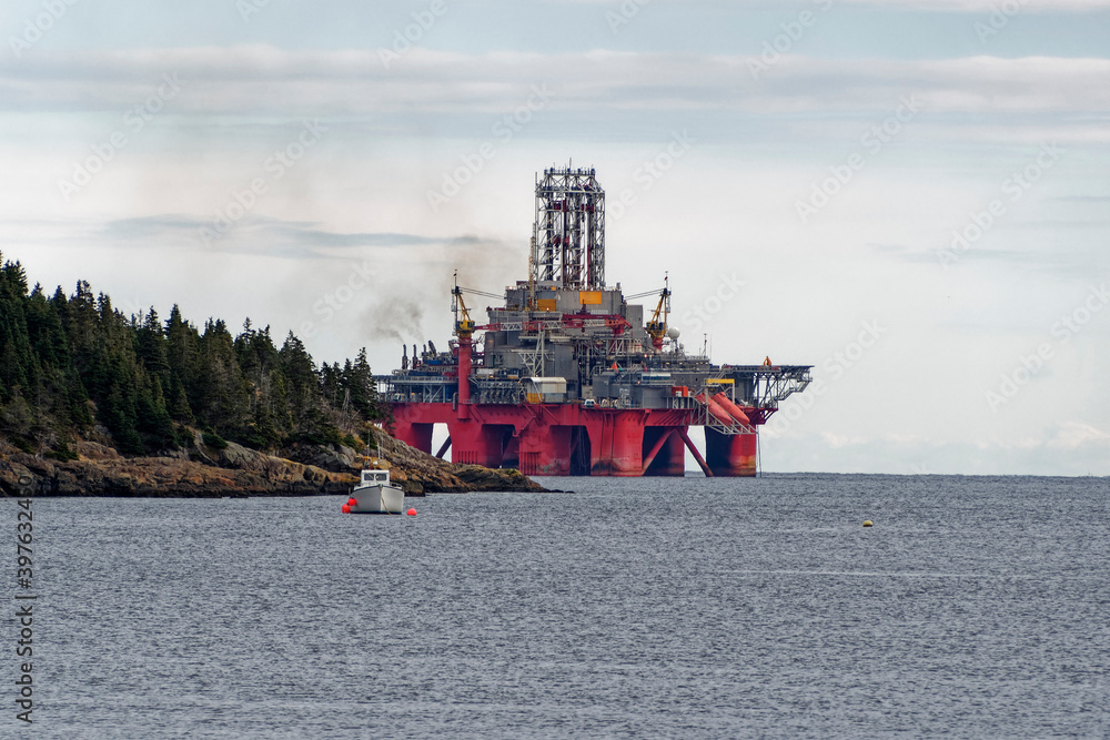 Deep water drill rig is moored near shore after finishing an ...