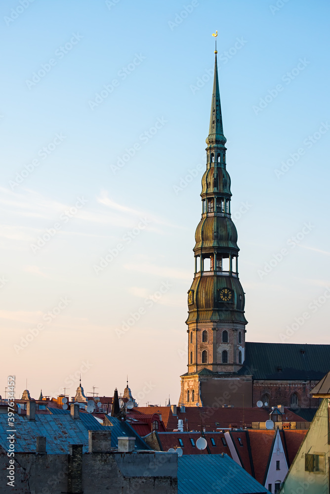 Symbol of Riga, old clock on medieval church tower among roofs ancient ...