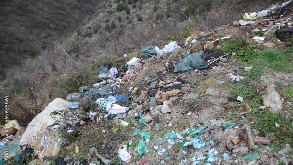 Illegal dumping. Wild garbage dump in nature. Open landfill site. Pile ...