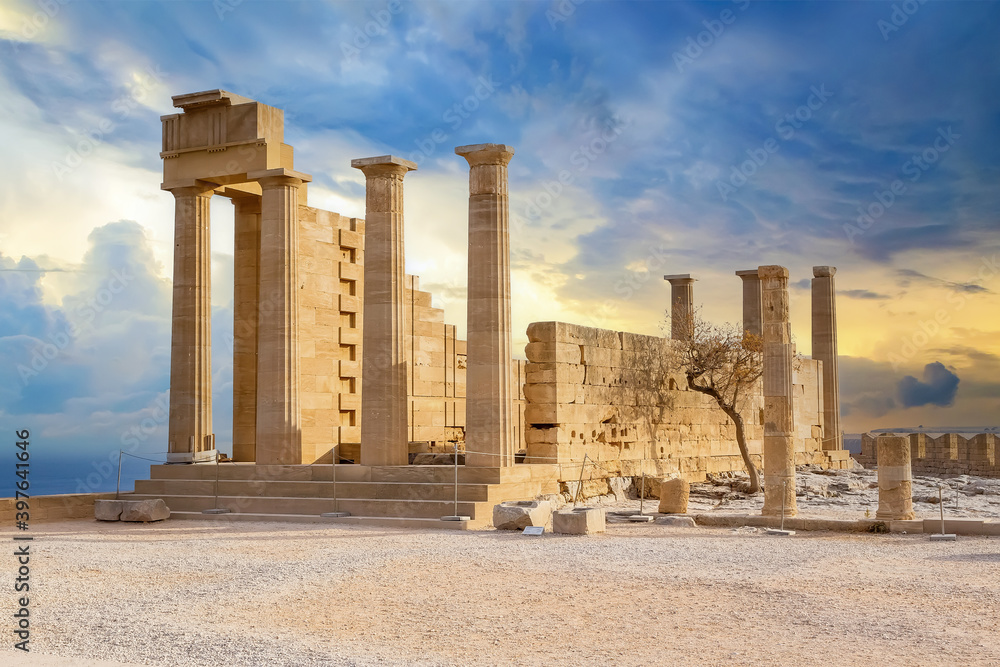 Ancient Greek acropolis. Front view of columns and walls. near the tree ...