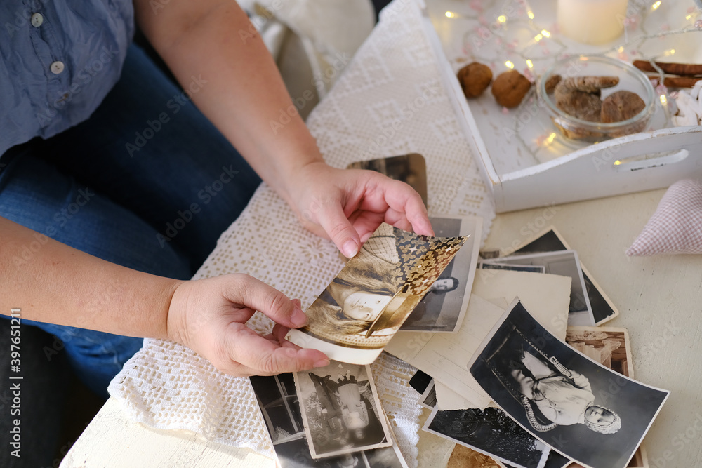 woman looking through her old photographs 1965-1970, concept of ...