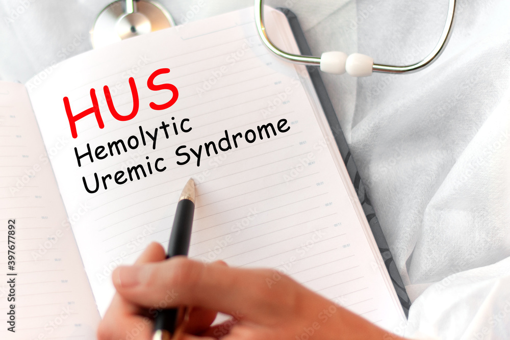 Doctor holding a card with text HUS - short for Hemolytic Uremic ...