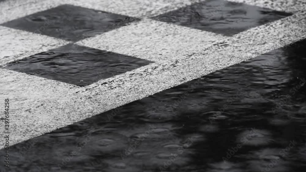 Wet race motorsport background, rain on checkered sign finish line ...