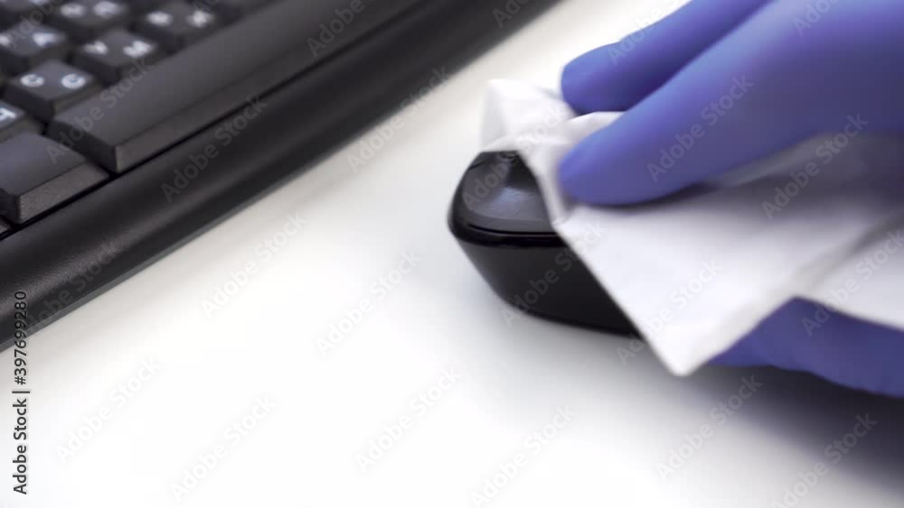Disinfection of a computer mouse with medical gloves and with a ...