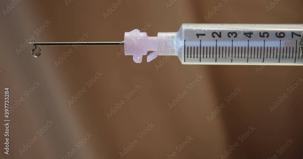 Locked-Off Syringe Slowly Dripping Liquid Stock Video | Adobe Stock