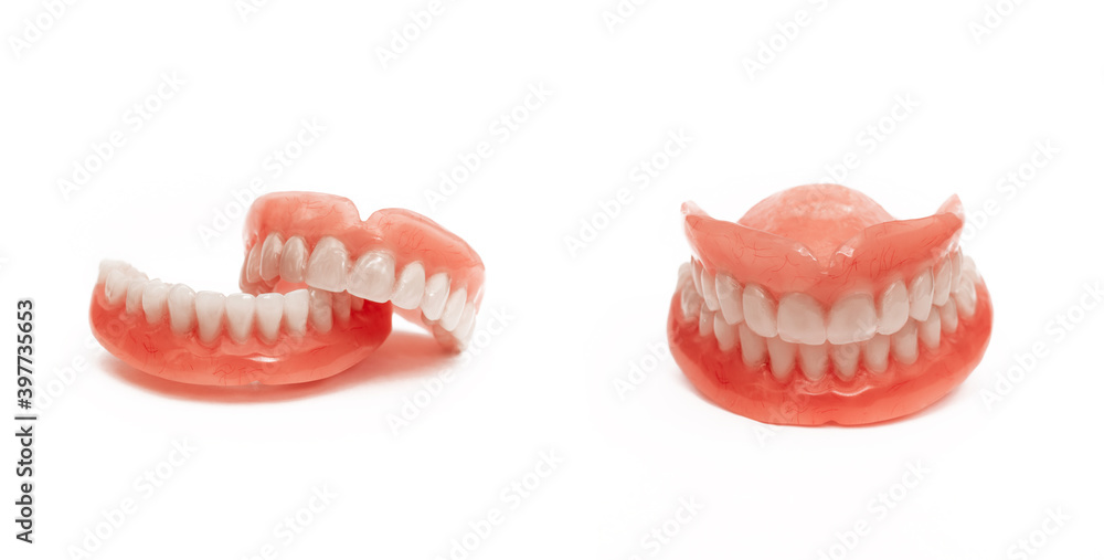 Full removable plastic denture of the jaws. Set of dentures on a white ...