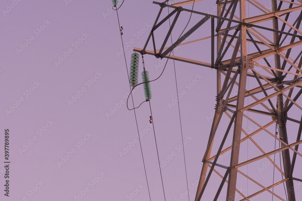 Power line at sunset. The main purpose of power lines is to transmit ...