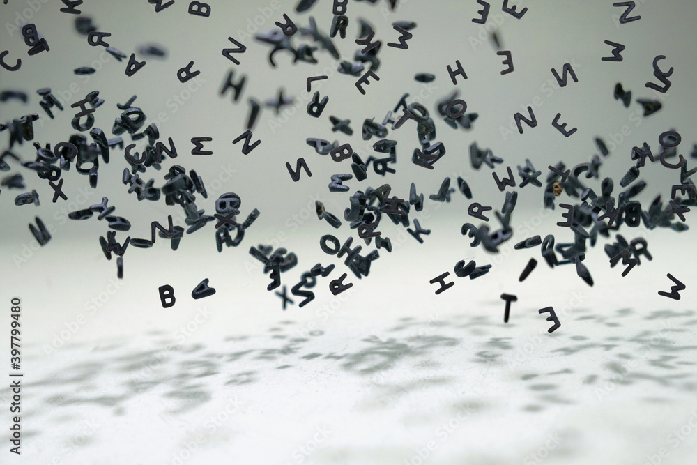 Letters of the alphabet falling and flying in levitation in the air ...