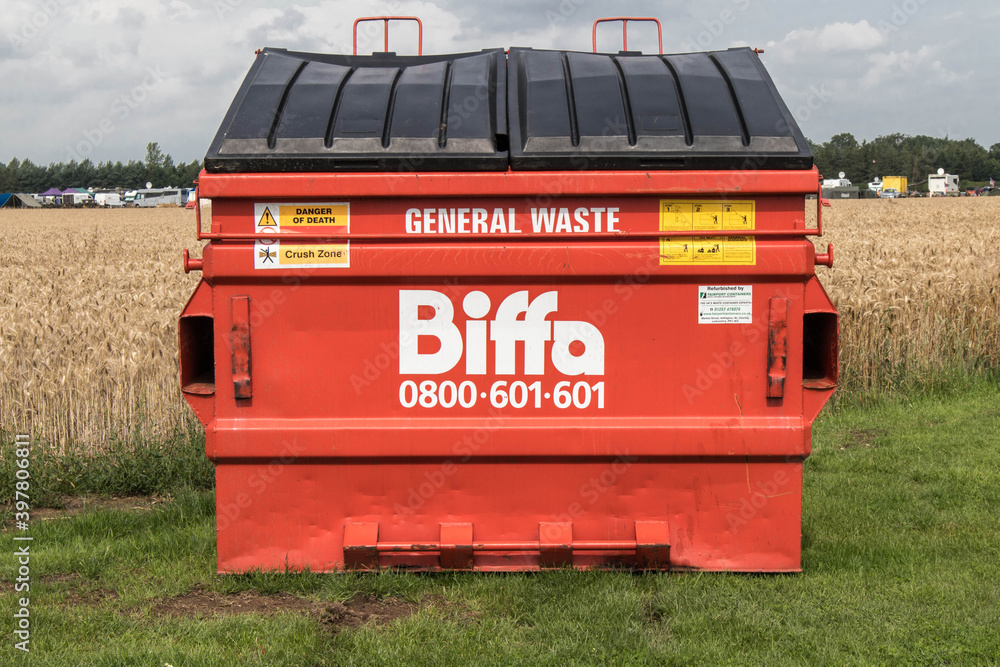 Large red Biffa General Waste container garbage rubbish bin in a field ...