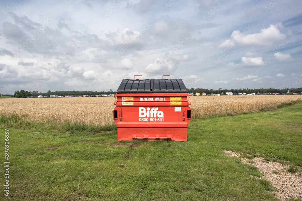Large red Biffa General Waste container garbage rubbish bin in a field ...