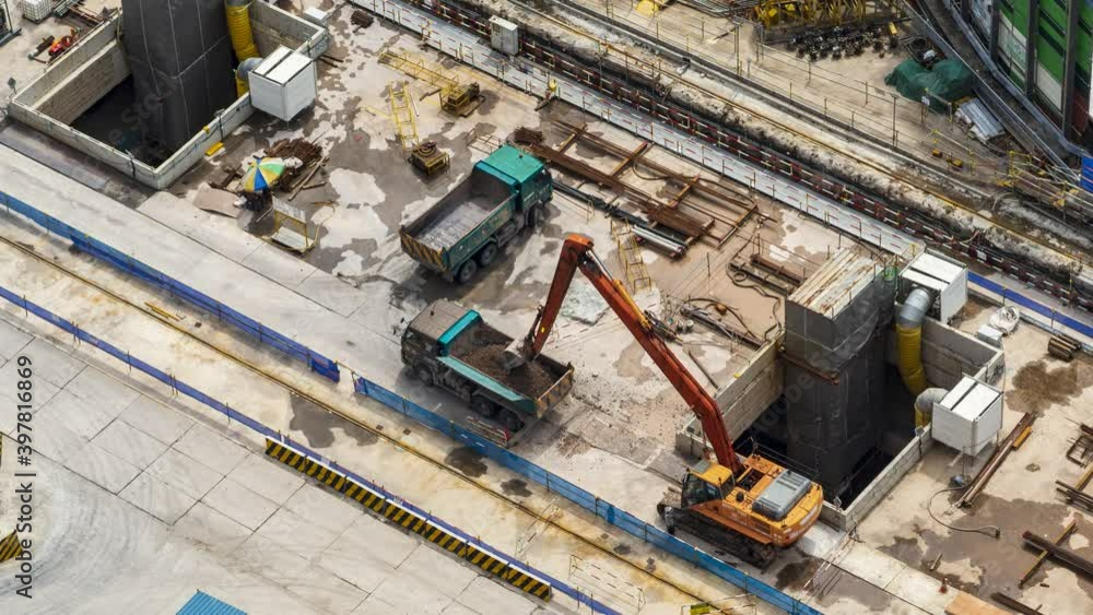 [4K Time lapse] Excavator digging a hole and dump trucks carry the soil ...