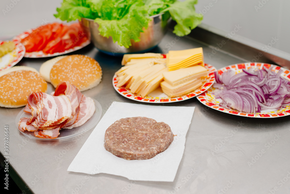 Raw burger cutlet. The process of making a burger in the kitchen in a ...