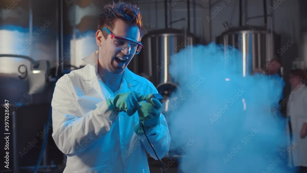 Evil professor pushing remote controller button in large industrial ...