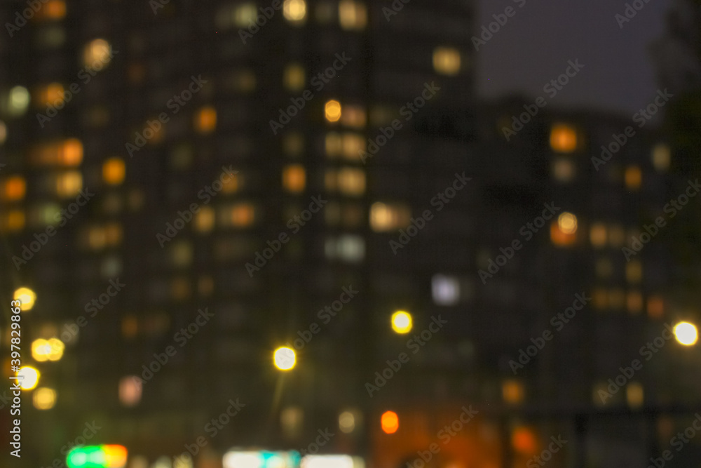The facade of the apartment building, blurred light in the windows at ...