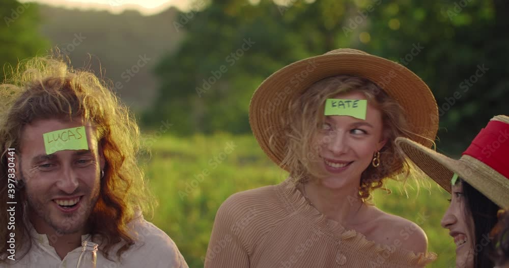 Millennial friends playing guessing game who am I while sitting with ...