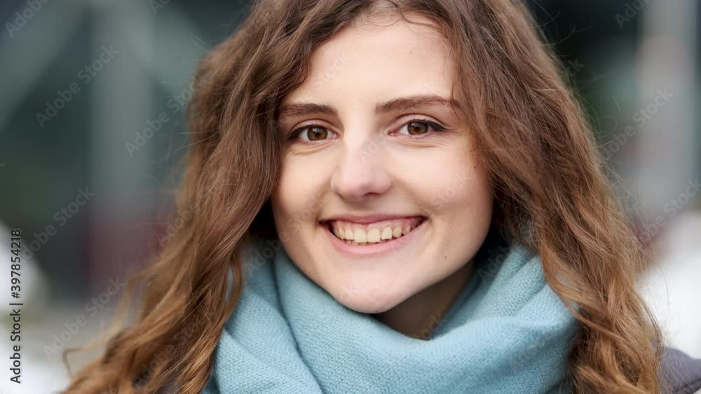Portrait attractive curly woman winking eye and smiling into camera ...